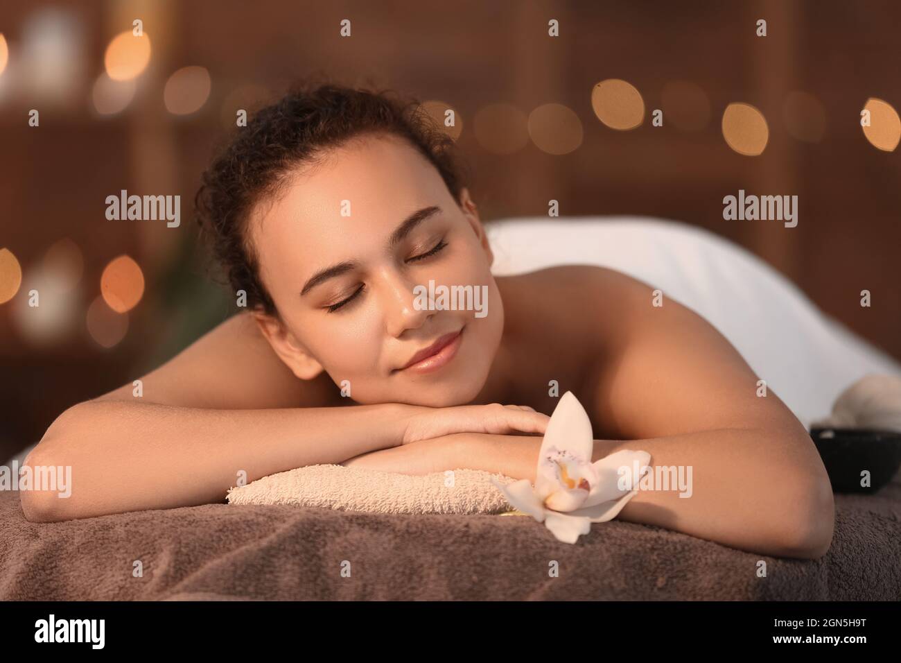 Beautiful young African-American woman relaxing in spa salon Stock ...