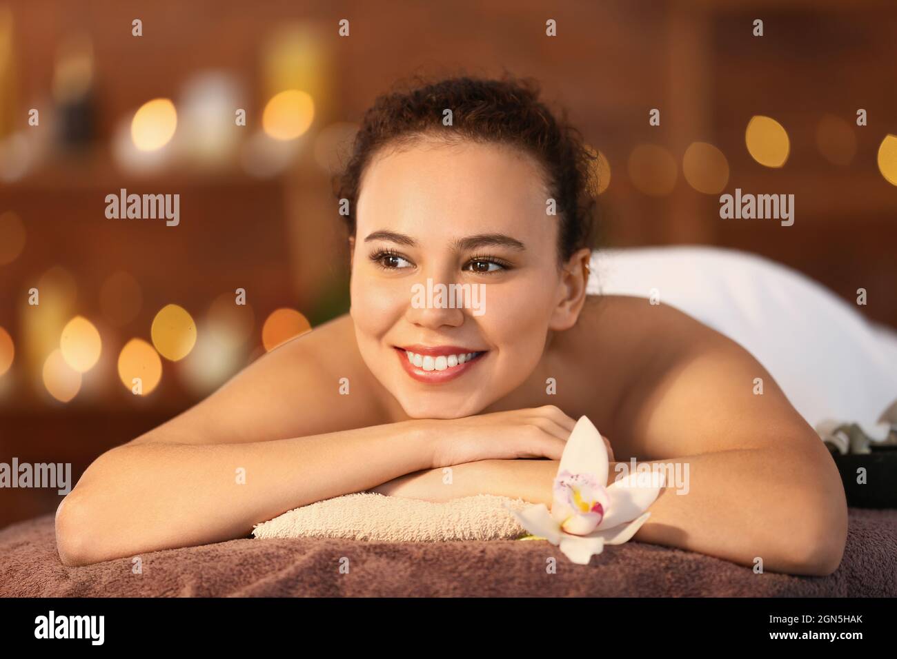 Beautiful young African-American woman relaxing in spa salon Stock ...