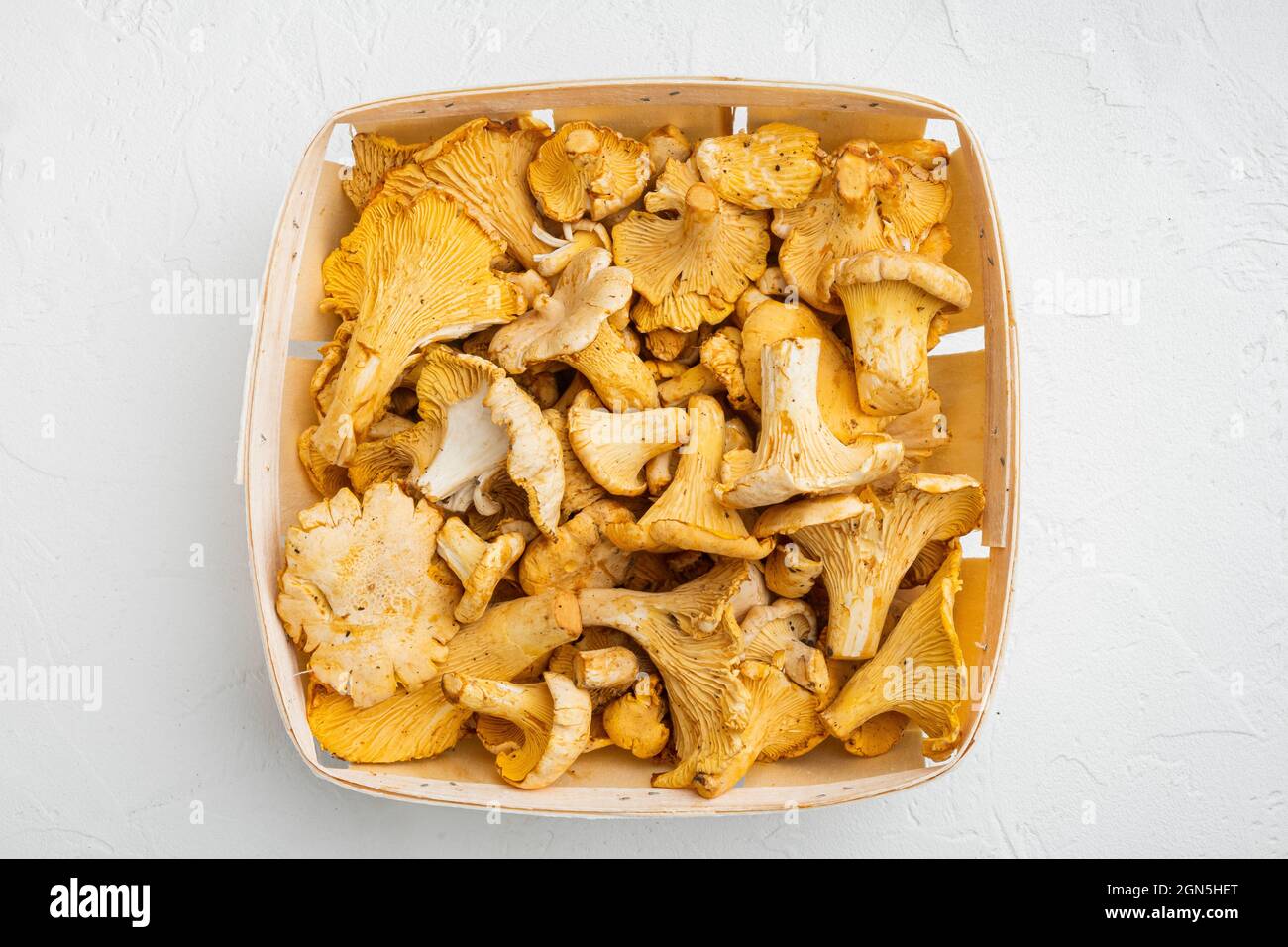Cantharellus cibarius, chanterelle mushrooms set, in wooden box ...
