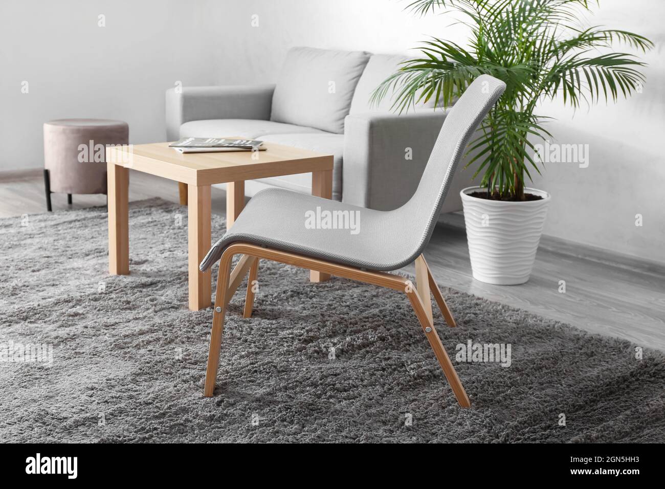 Interior of stylish room with modern armchair Stock Photo - Alamy