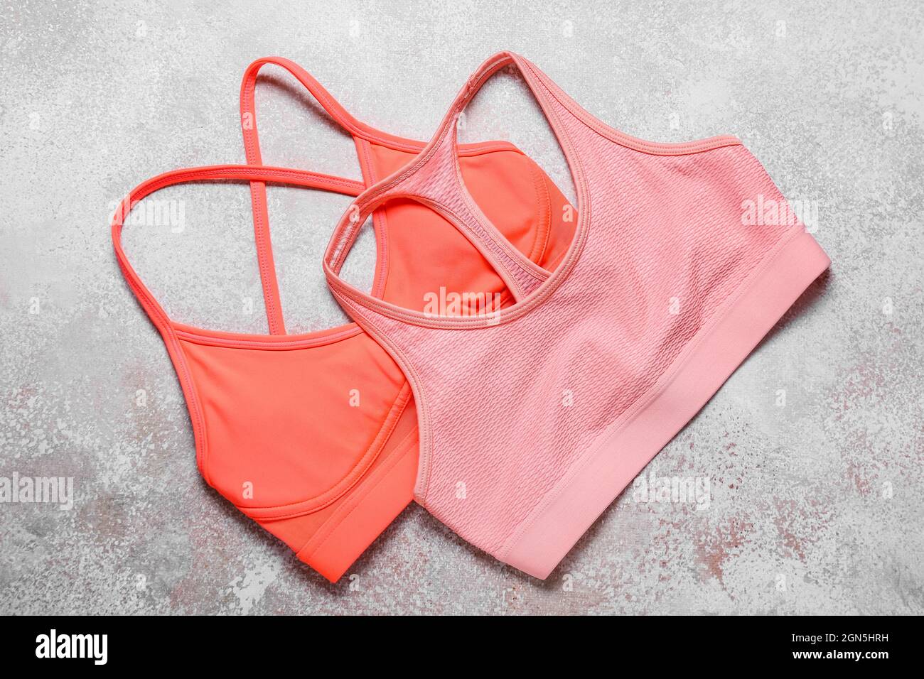 Different sports tops on light background Stock Photo - Alamy