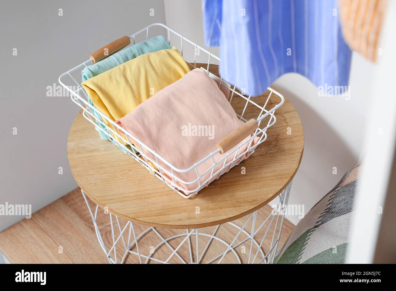 Wardrobe organizer with clothes on table in dressing room, closeup ...