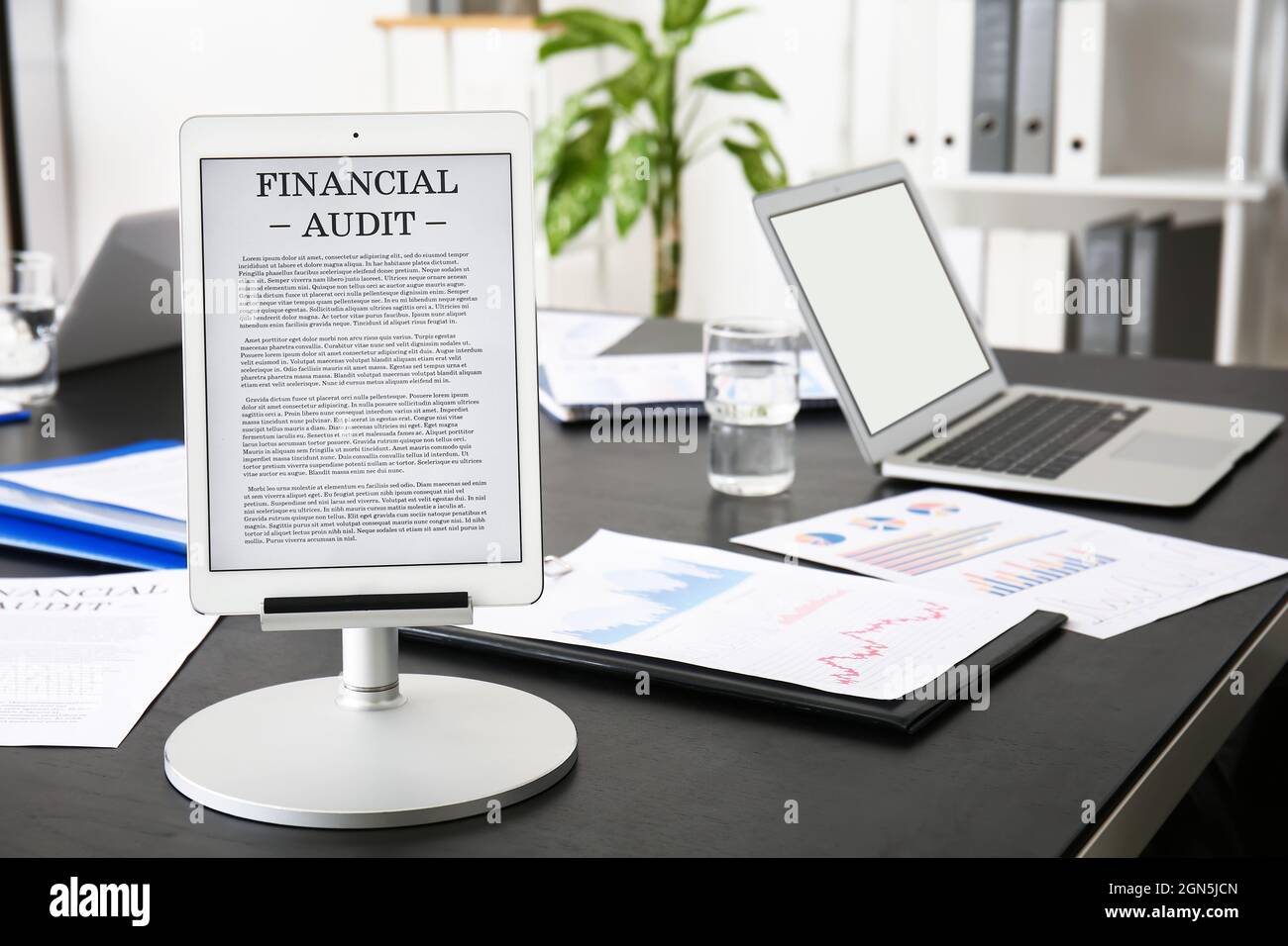 Tablet computer with financial audit on table in office Stock Photo - Alamy