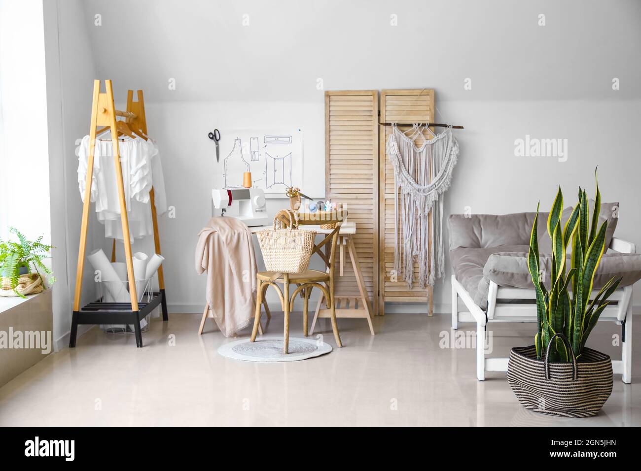 Interior of modern tailor's workshop with clothes Stock Photo - Alamy