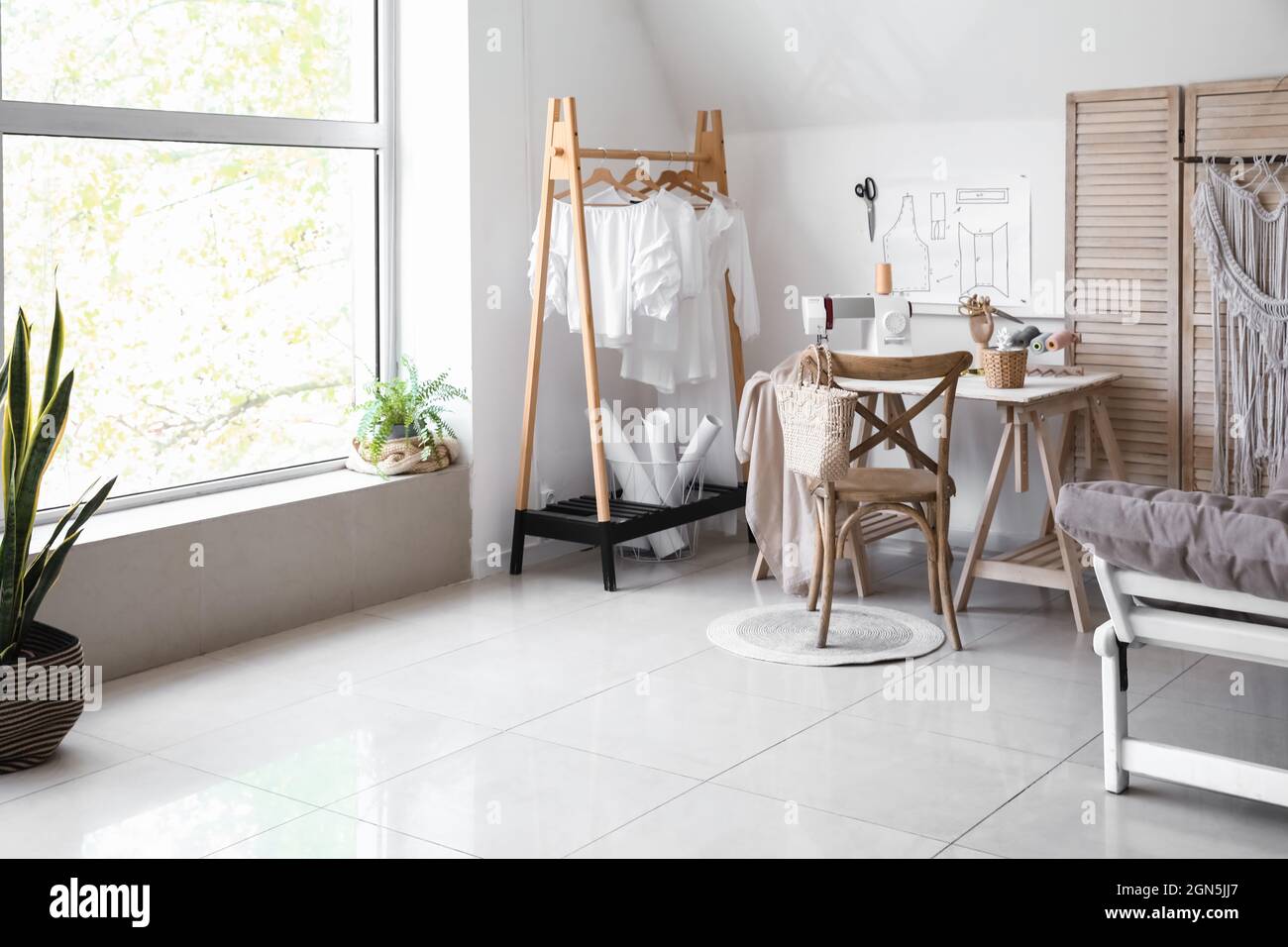Interior of modern tailor's workshop with clothes Stock Photo - Alamy