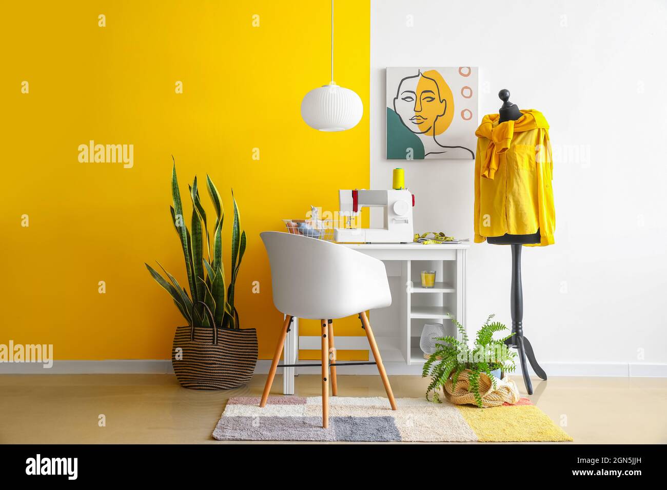 Interior of stylish tailor's workshop with mannequin Stock Photo - Alamy