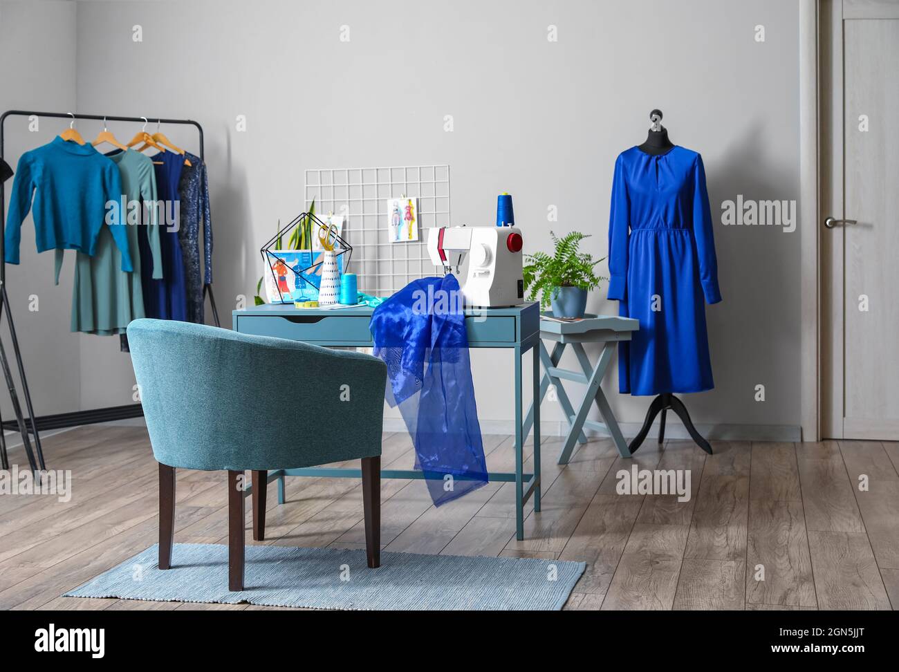 Tailor's workplace with sewing machine in stylish atelier Stock Photo ...