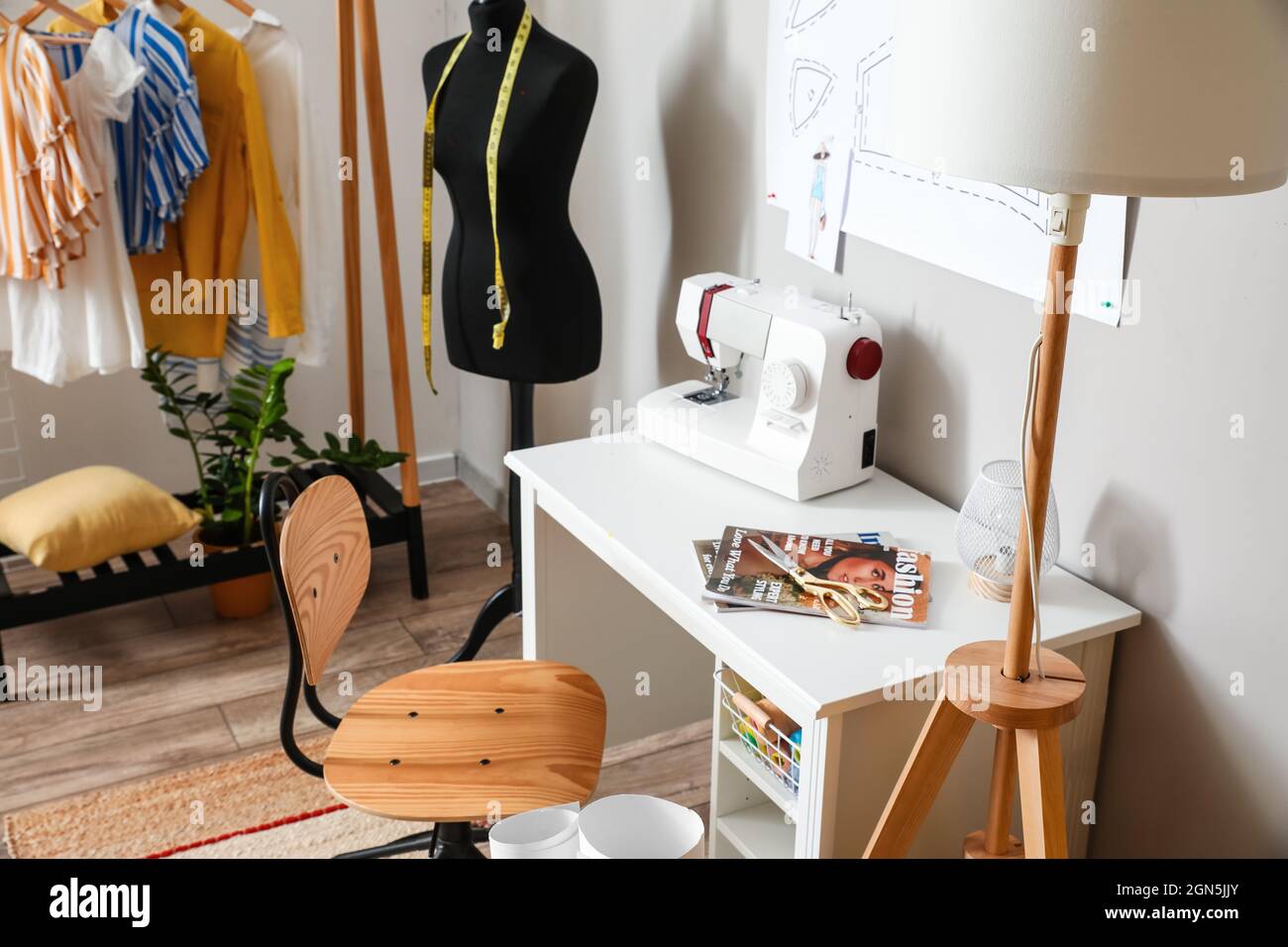 Tailor's workplace with sewing machine and magazines in atelier Stock ...