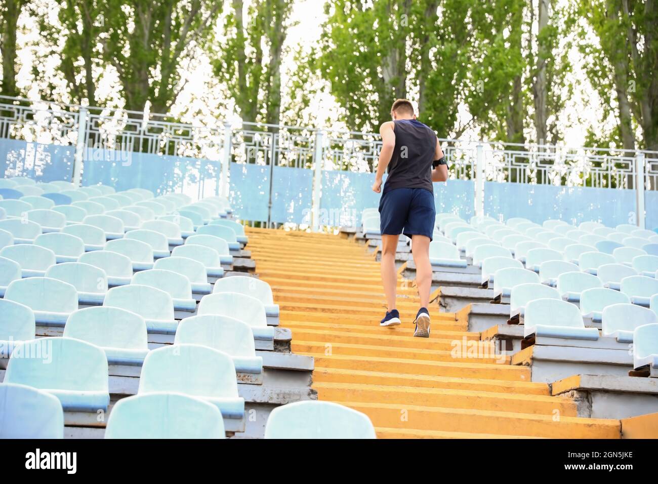 Young man running upstairs hi-res stock photography and images - Alamy