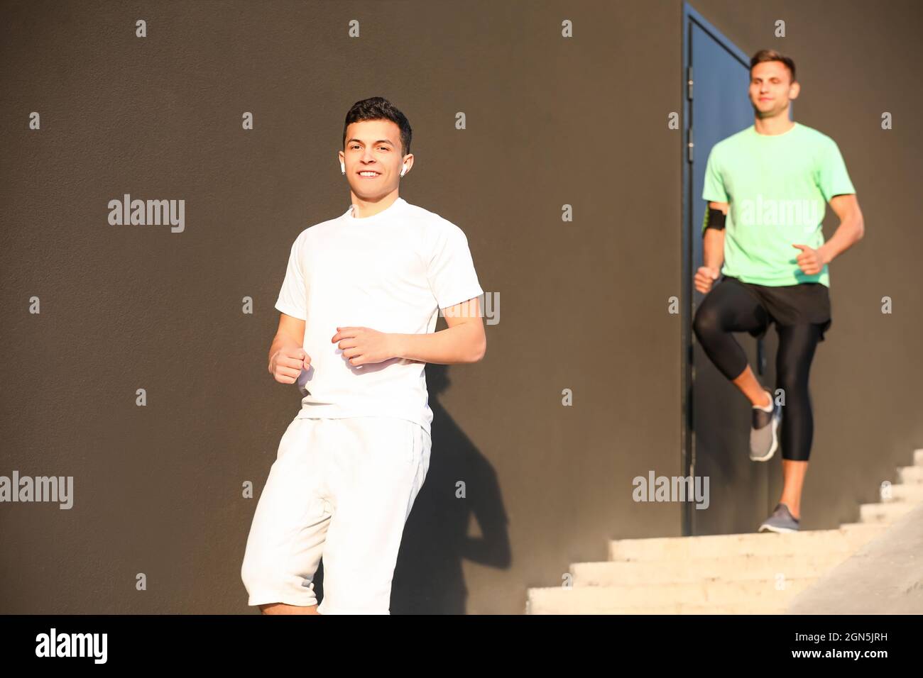Sporty young man running downstairs outdoors Stock Photo - Alamy