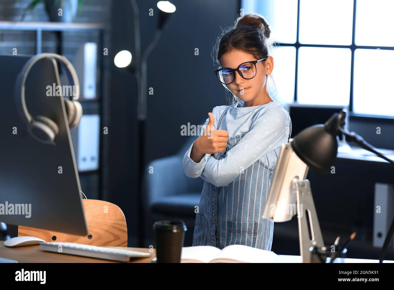 Little programmer showing thumb-up in office at night Stock Photo - Alamy