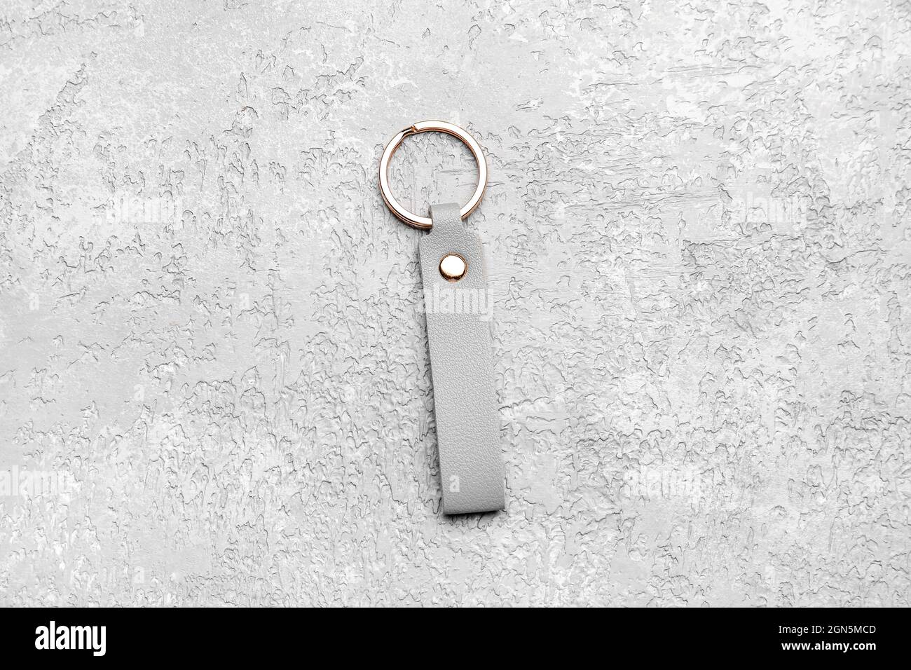 Leather keychain on grey background Stock Photo - Alamy