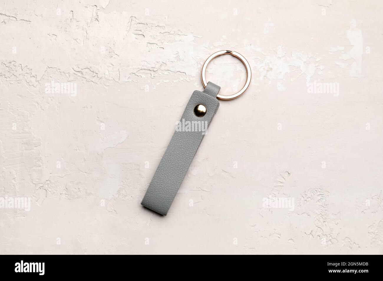 Leather keychain on light background Stock Photo - Alamy