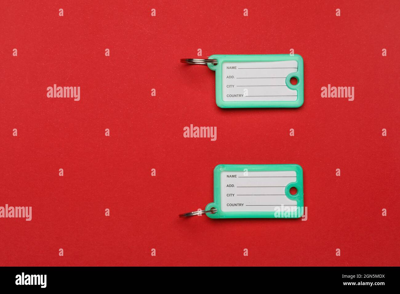 Plastic key tags on color background Stock Photo - Alamy
