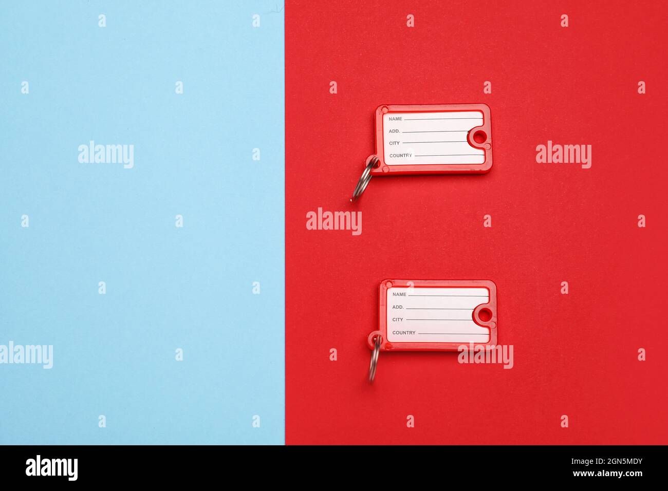 Plastic key tags on color background Stock Photo - Alamy