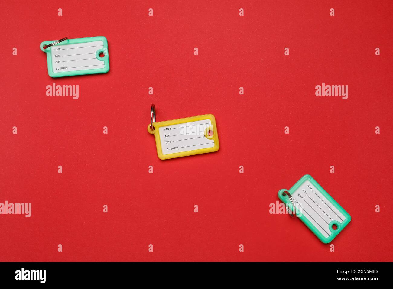 Plastic key tags on color background Stock Photo - Alamy