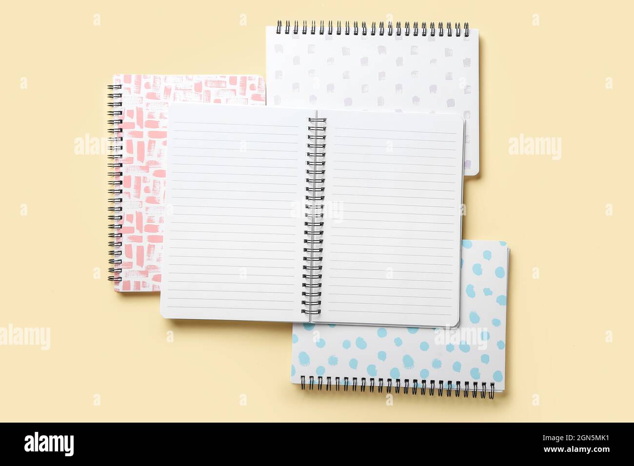 Different notebooks on color background Stock Photo - Alamy