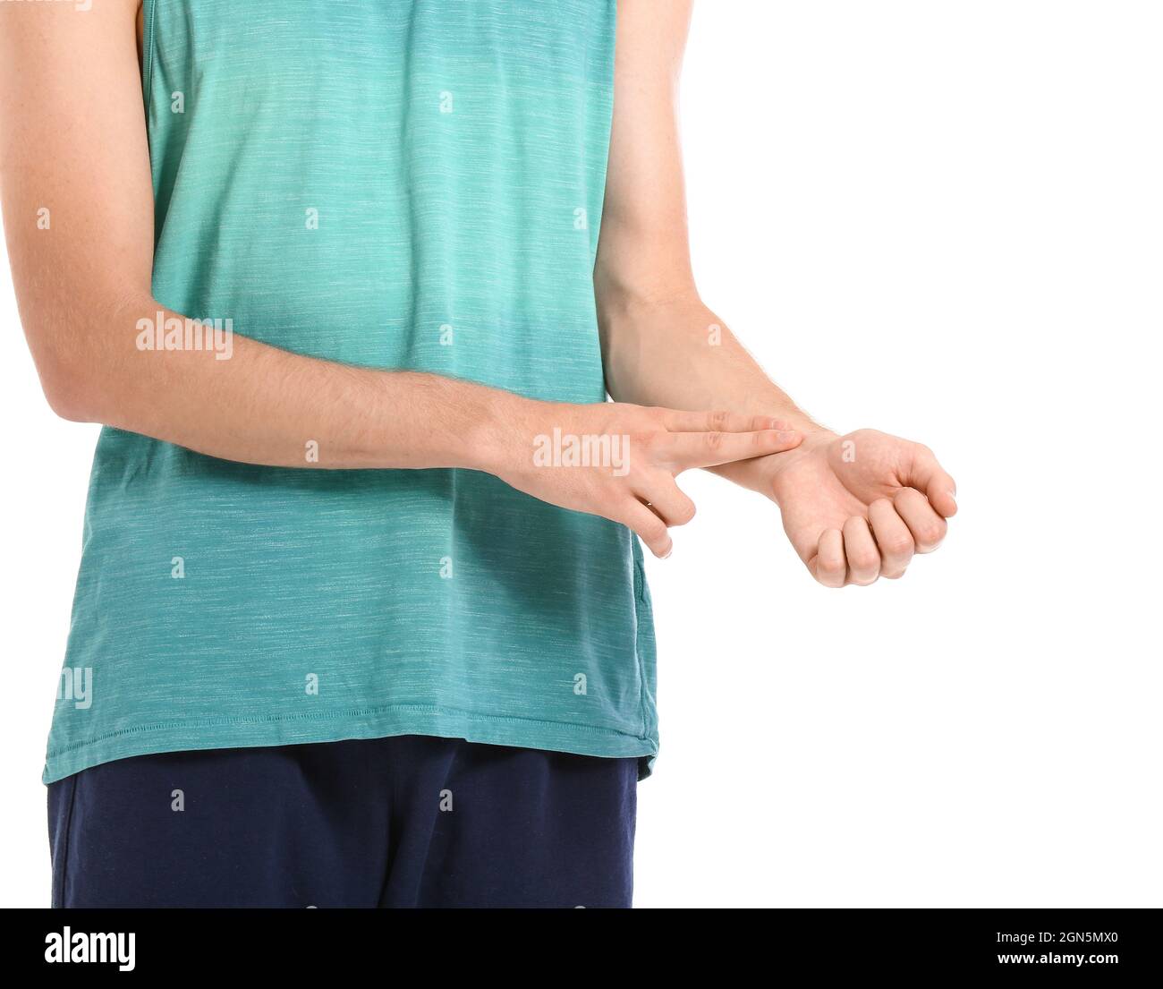 Sporty young man counting pulse on white background Stock Photo - Alamy