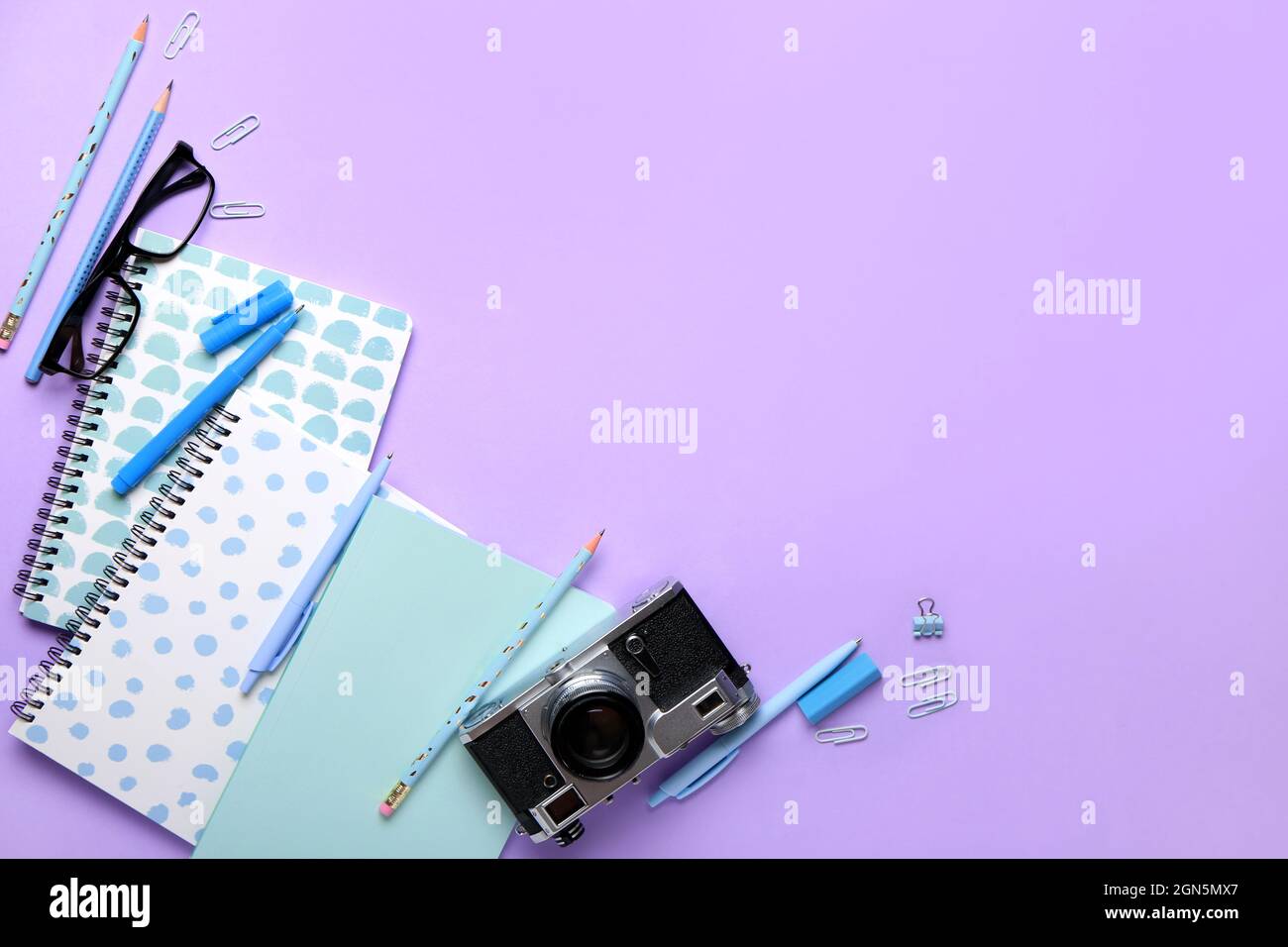 Stationery supplies, glasses and photo camera on color background Stock ...