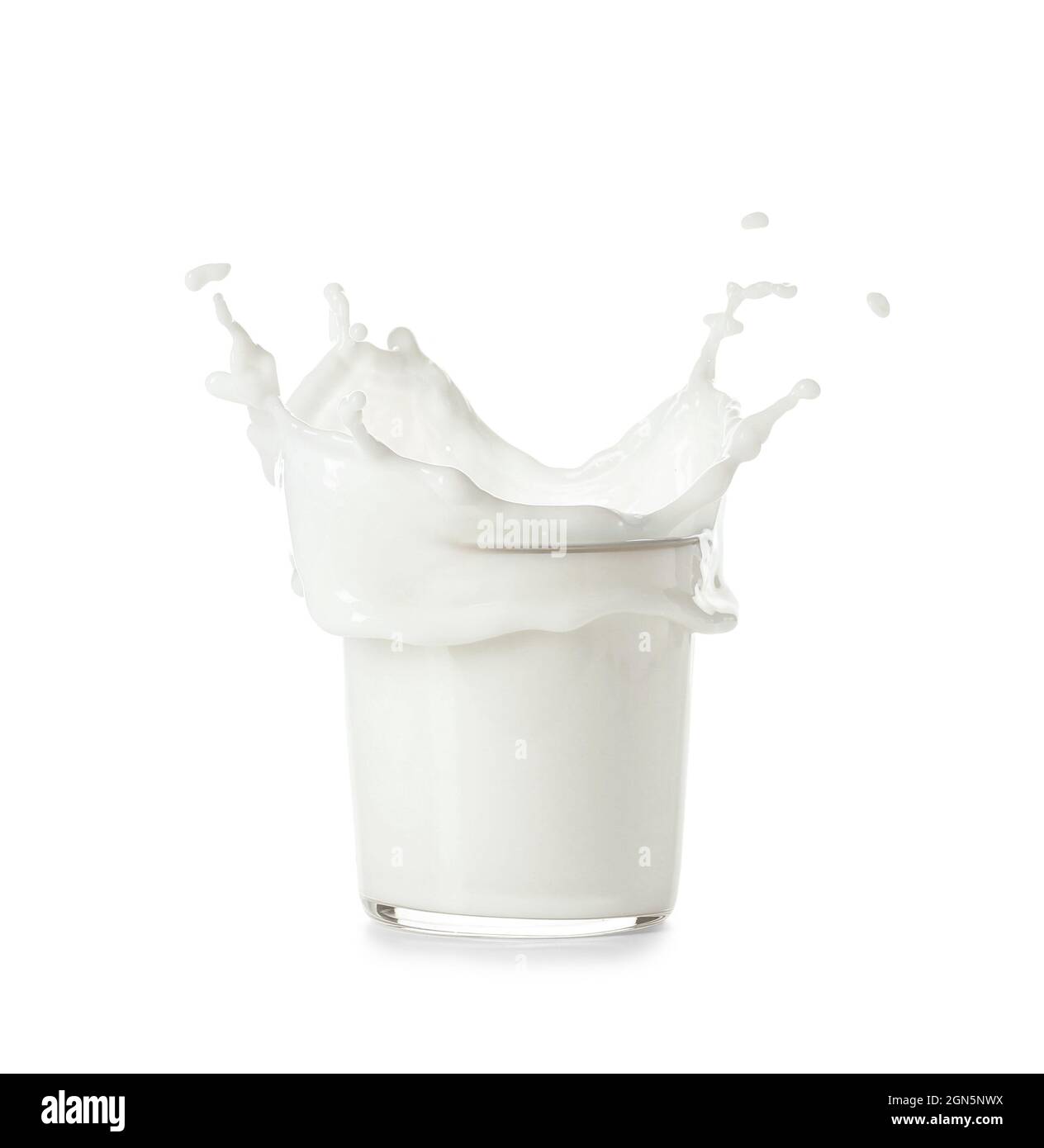 Glass of white milk splashing on white background Stock Photo - Alamy