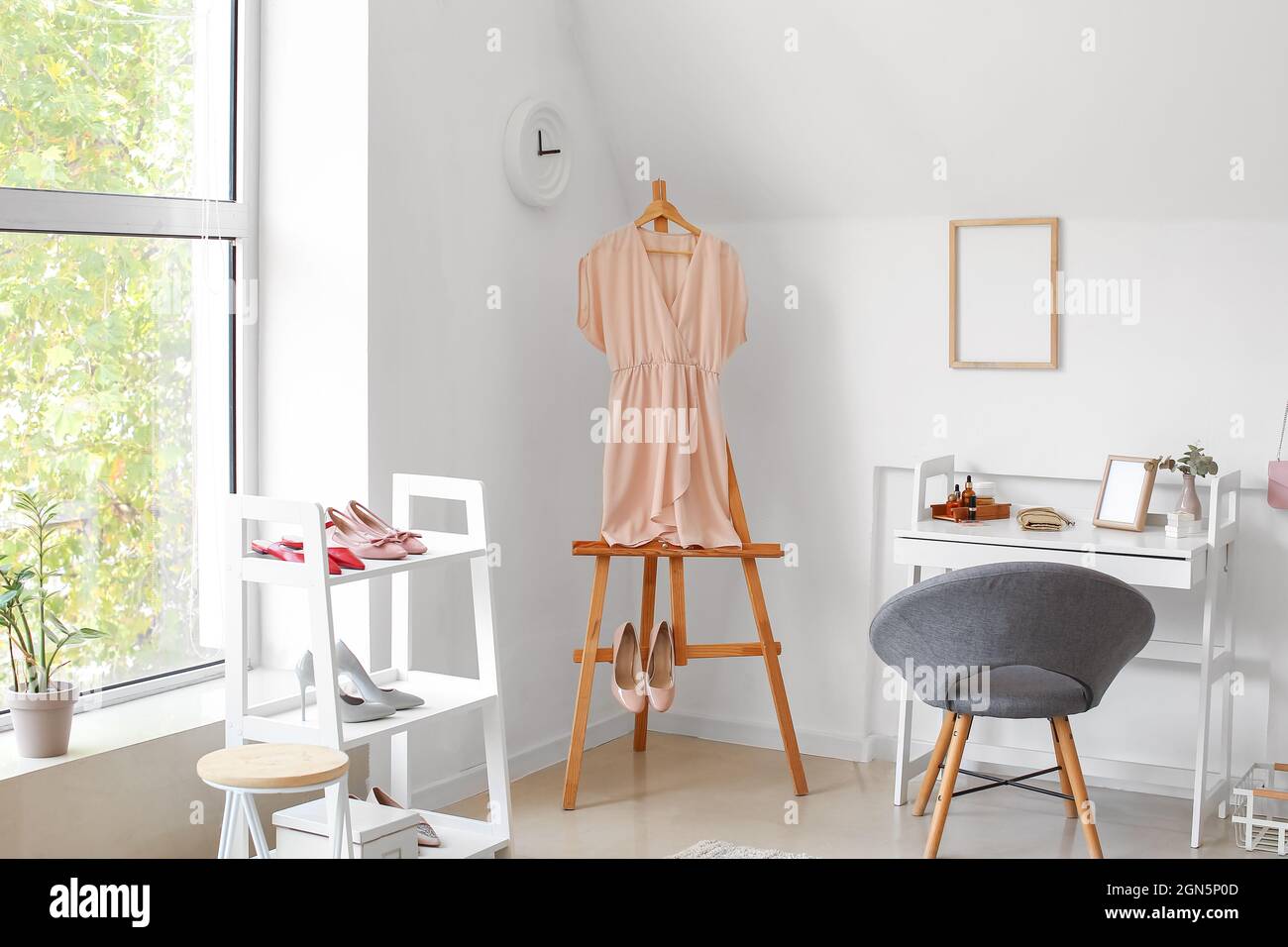 Interior of stylish room with clothes Stock Photo - Alamy
