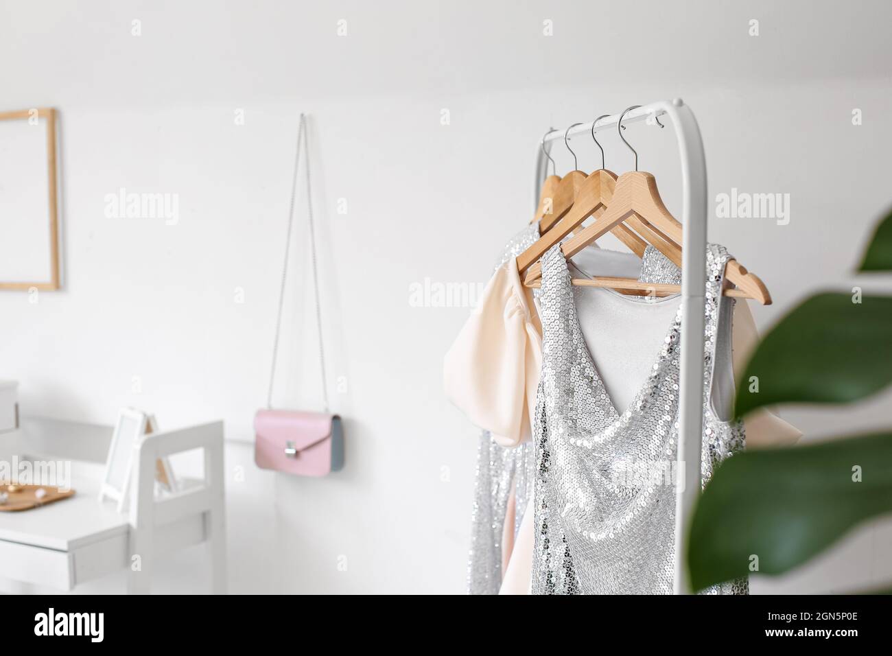 Rack with stylish clothes in room Stock Photo - Alamy