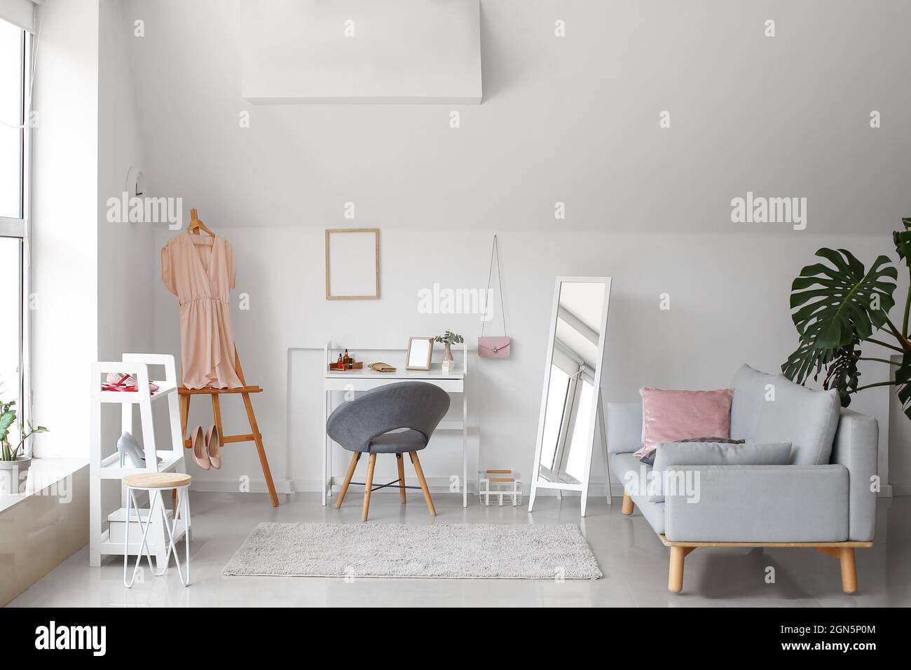 Interior of stylish room with clothes Stock Photo - Alamy