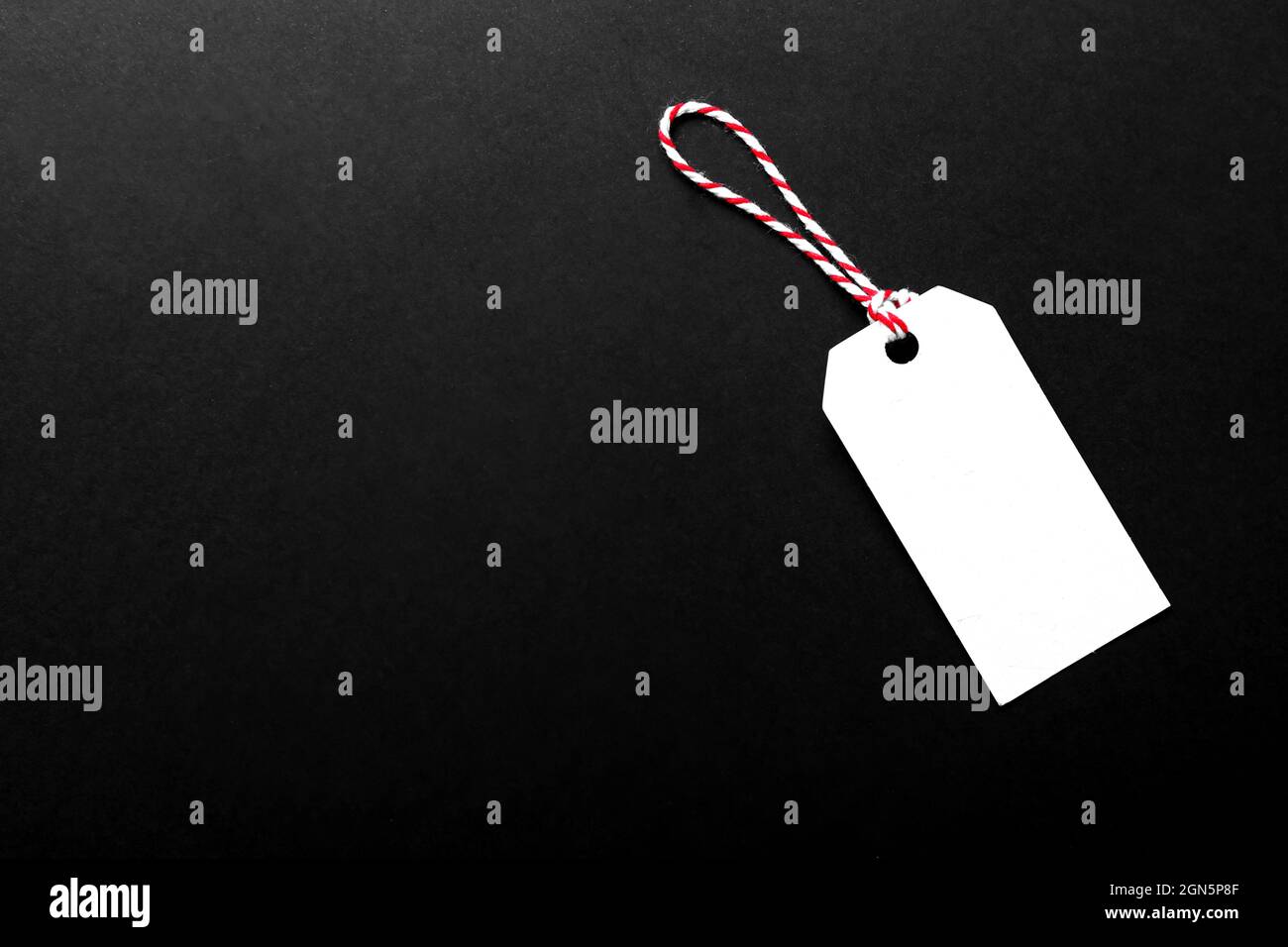 Blank tag on black background Stock Photo - Alamy