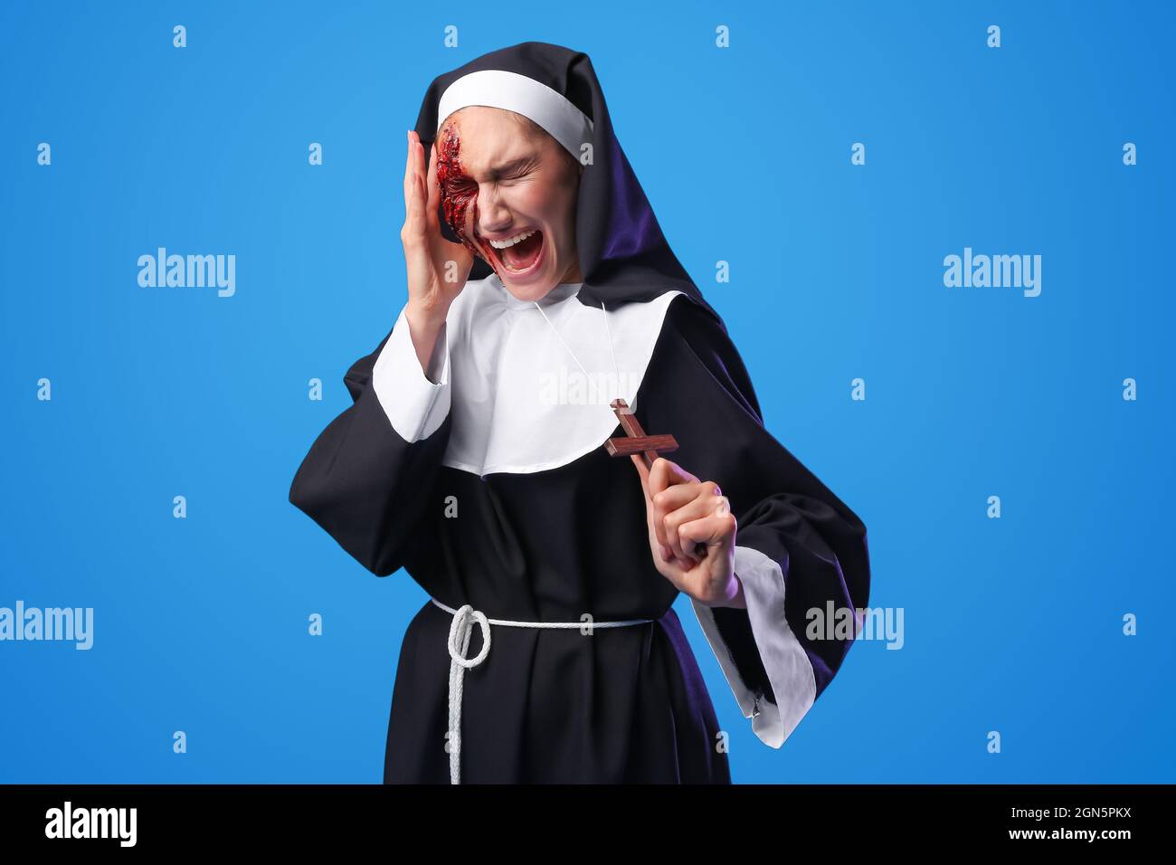 Screaming woman dressed for Halloween as nun on color background Stock ...