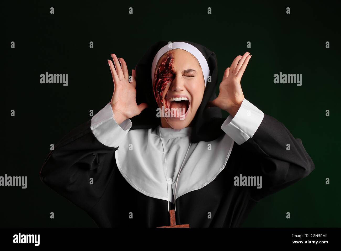 Screaming woman dressed for Halloween as nun on dark background Stock ...
