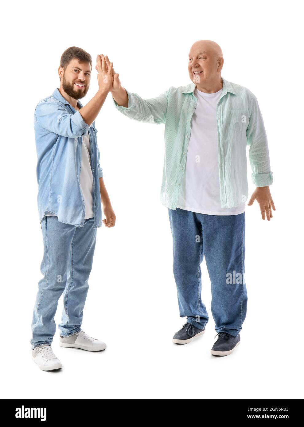 Happy man and his father giving each other high-five on white ...