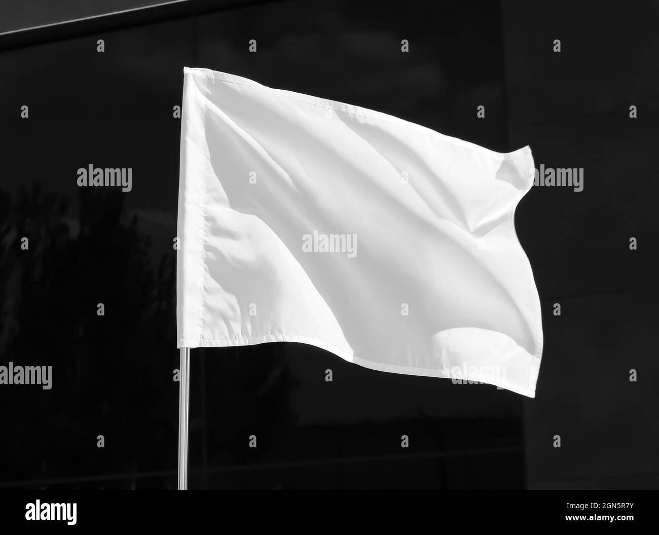 View of waving white flag outdoors Stock Photo - Alamy