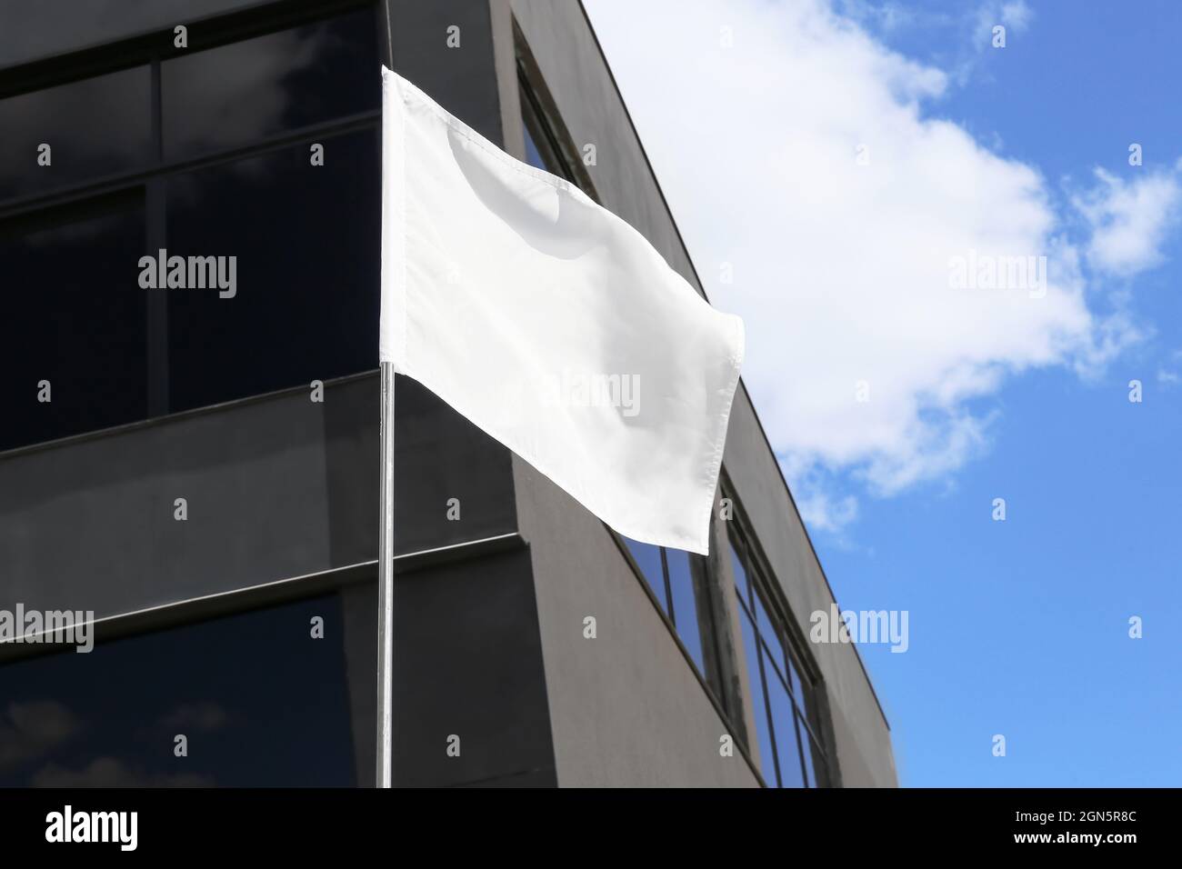 View of waving white flag outdoors Stock Photo - Alamy