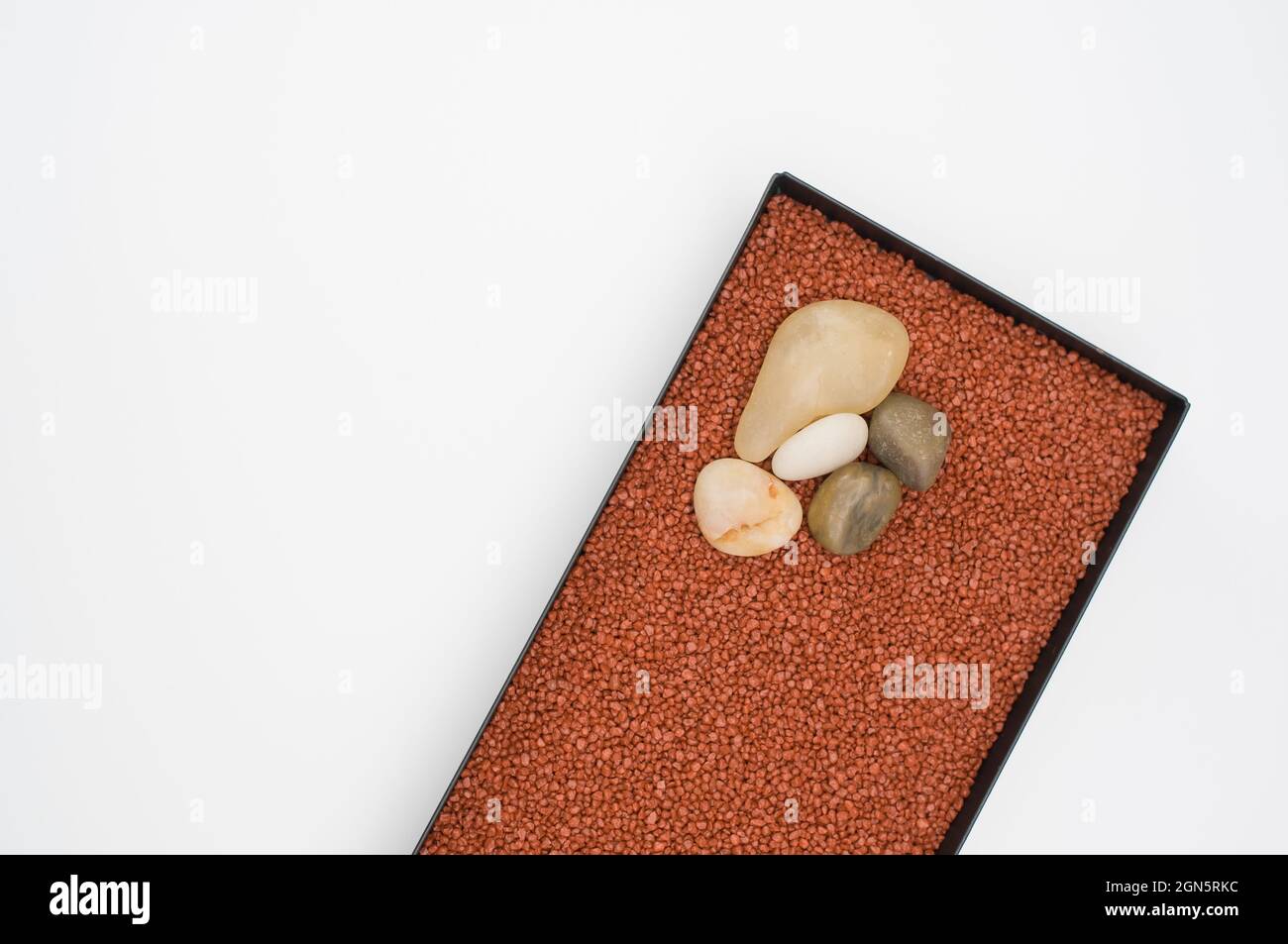 decorative orange colored sand in a metal box with pebbles Stock Photo ...