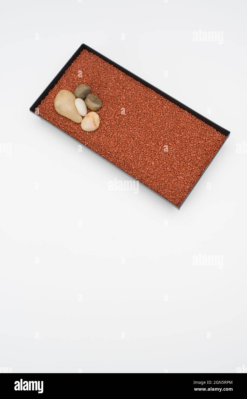 decorative orange colored sand in a metal box with pebbles Stock Photo ...