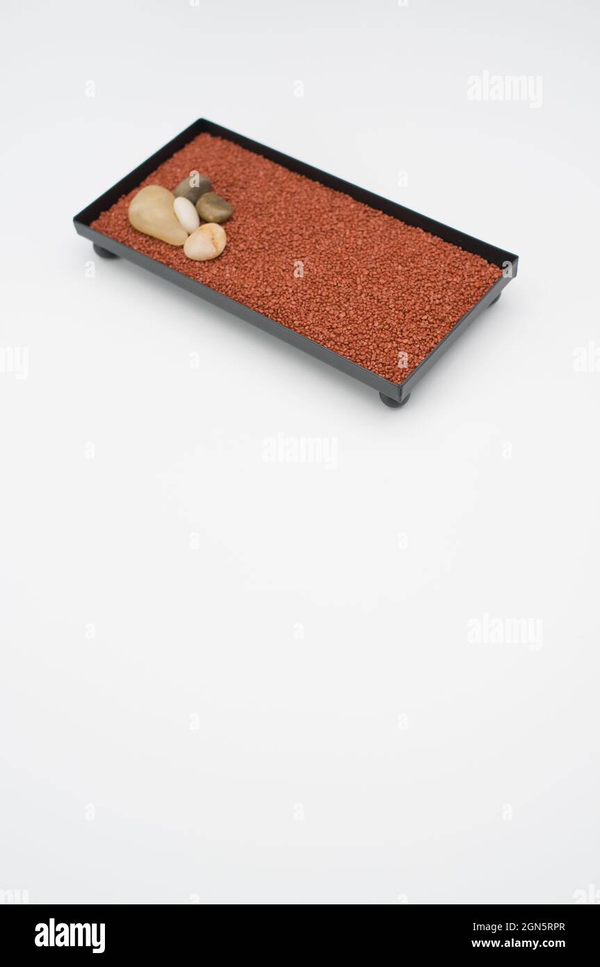 decorative orange colored sand in a metal box with pebbles Stock Photo ...