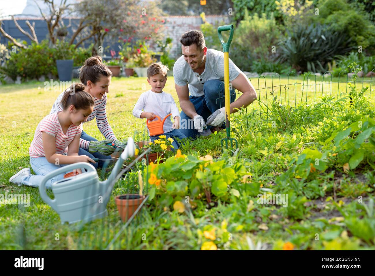 Happy young family gardening together hi-res stock photography and ...