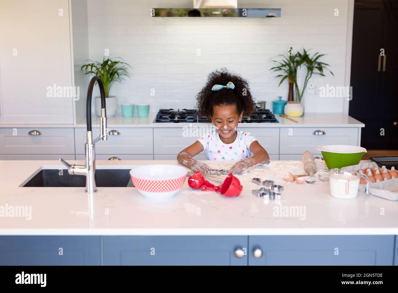 Happy african american messy girl baking in kitchen Stock Photo - Alamy