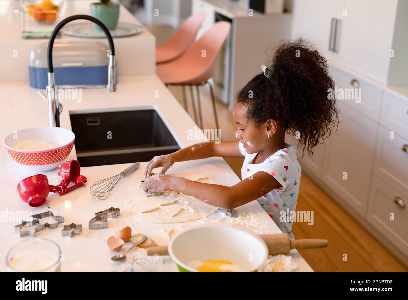Focused african american messy girl baking in kitchen Stock Photo - Alamy