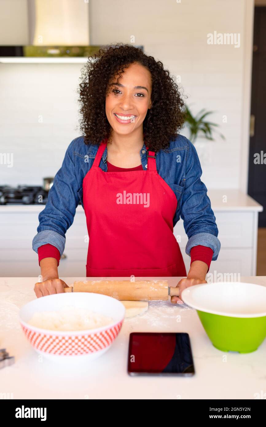 Portrait of happy african american woman wearing apron, baking in ...