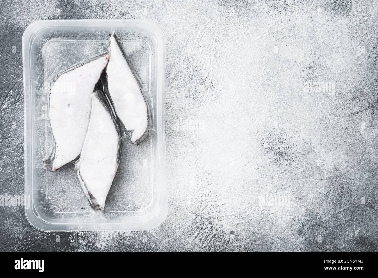 Frozen halibut pack set, on gray stone table background, top view flat ...