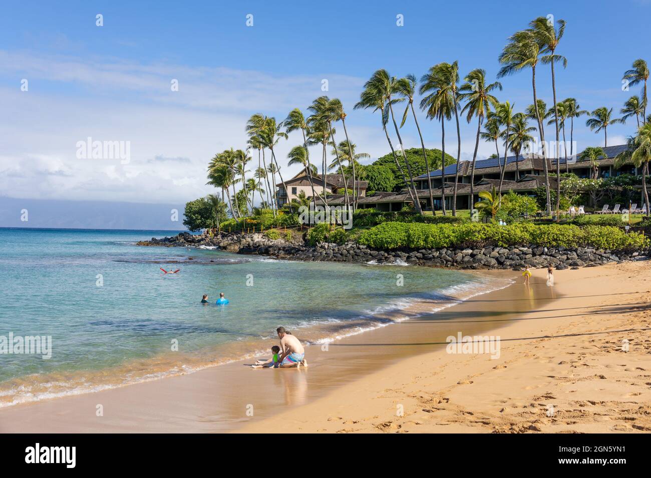 Tourist enjoying tropical beach with white sand and crystal clear water ...