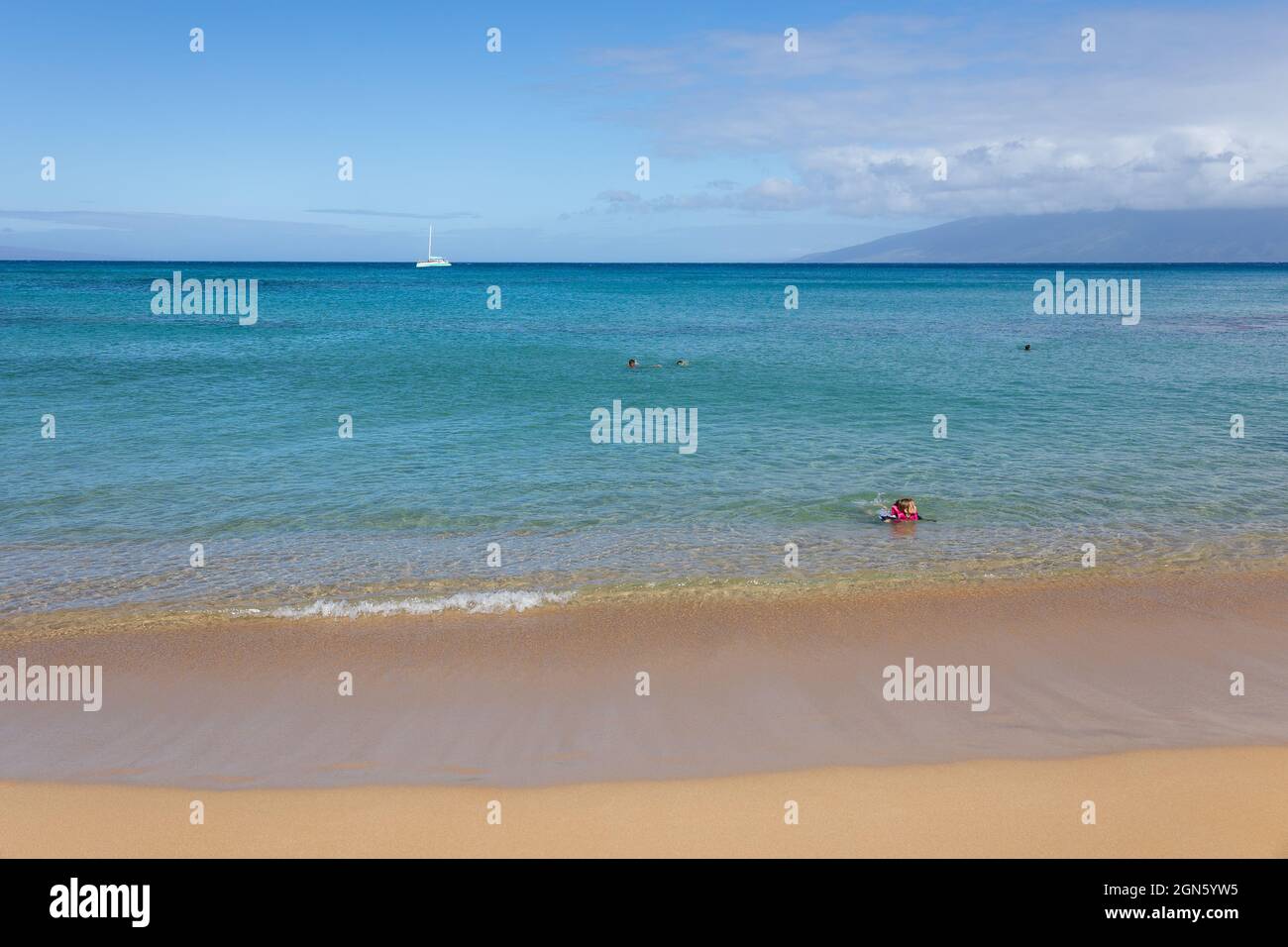 Tourist swimming at tropical beach with white sand and crystal clear ...