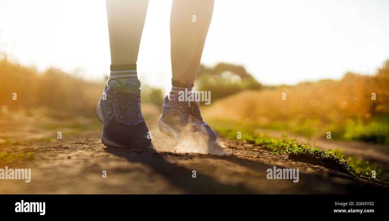 Female athletic legs and dust from the trail close up Stock Photo - Alamy