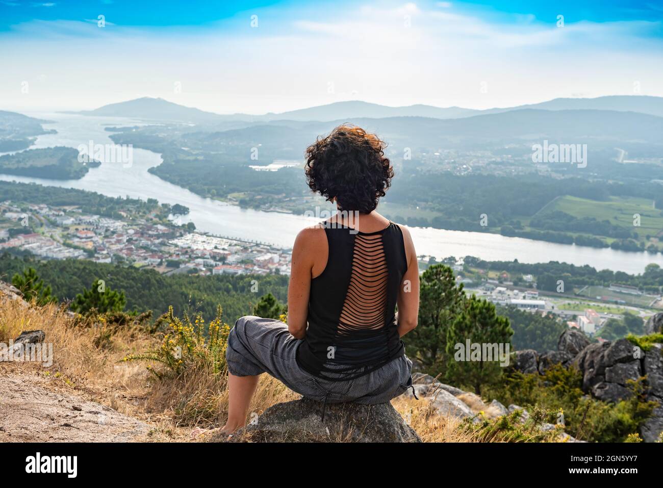 canyon landscape of the mouth of a river with a curly-haired Caucasian ...