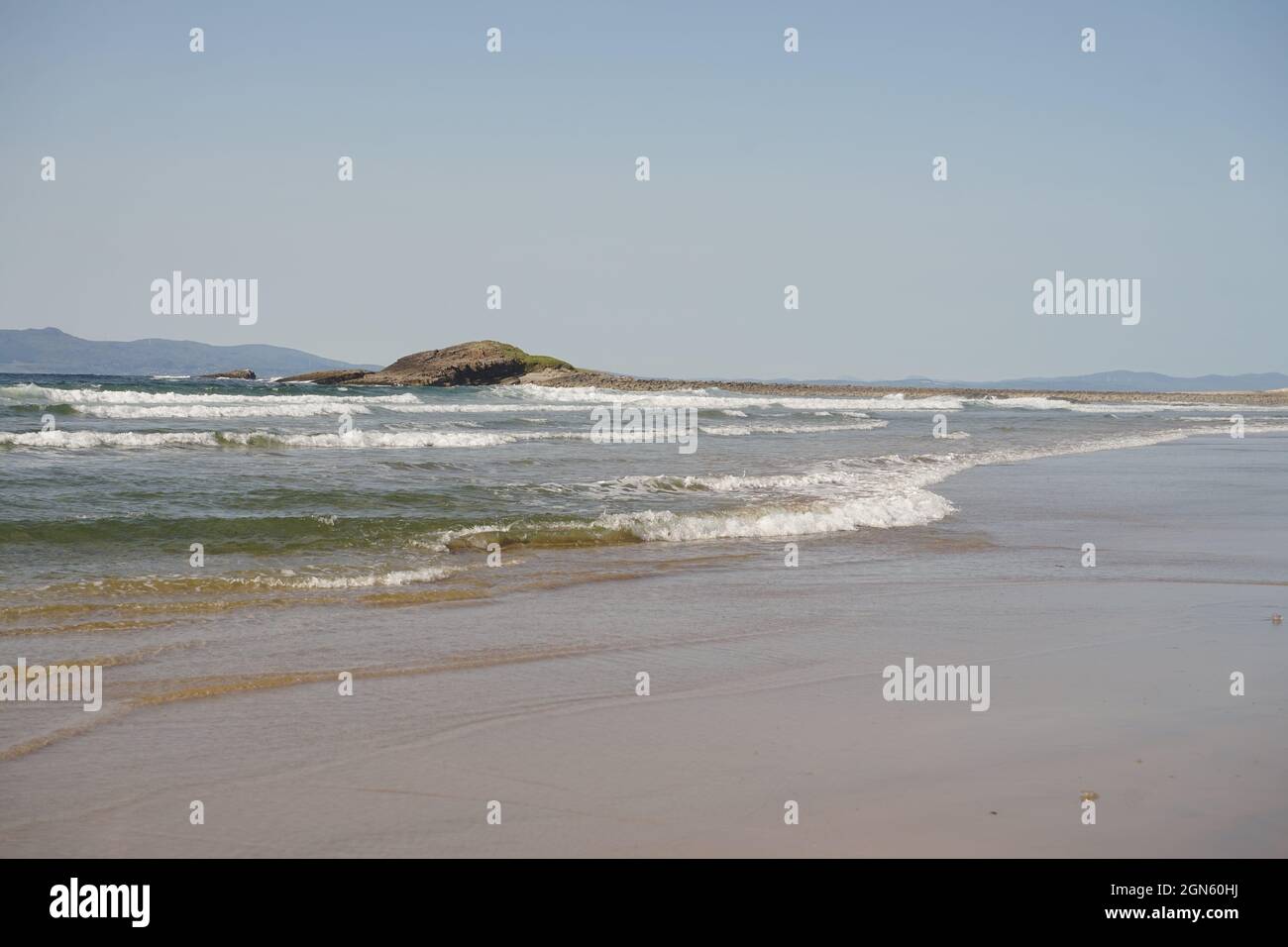 Seawater waves splashing on the sandy shore in the morning Stock Photo ...