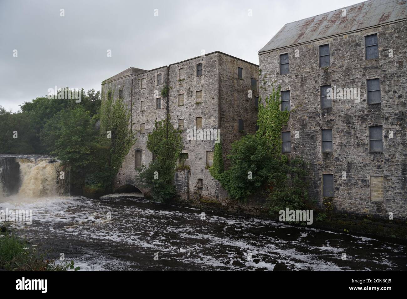 Raging water of a waterfalls going into a stream beside the Collooney ...