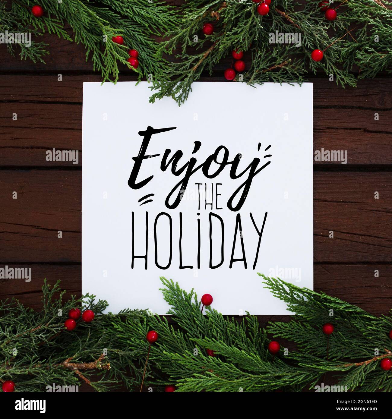 Wooden background with the text "Enjoy the holiday" in the middle and ...