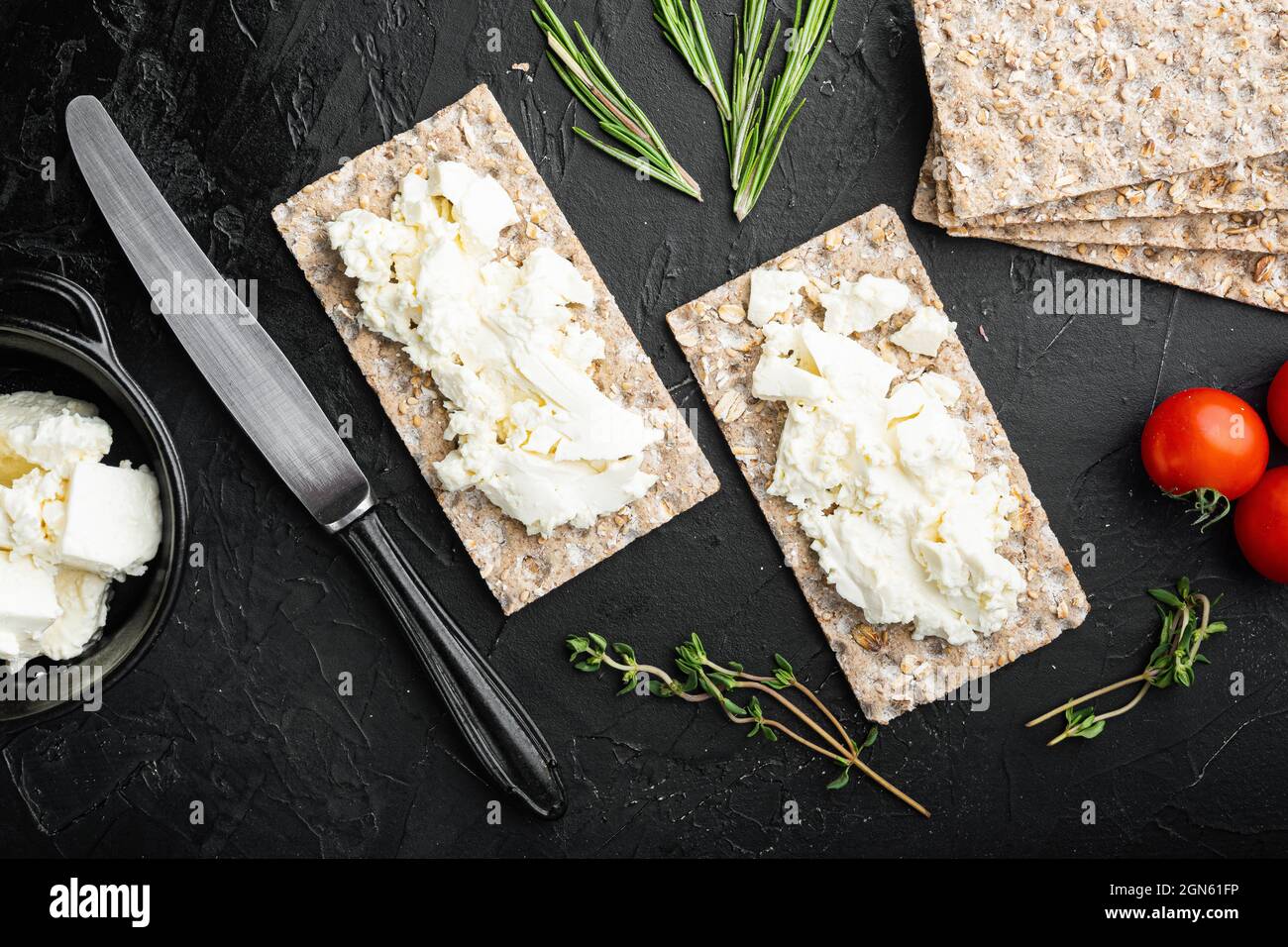 Crispbread sandwich set, on black dark stone table background, top view ...