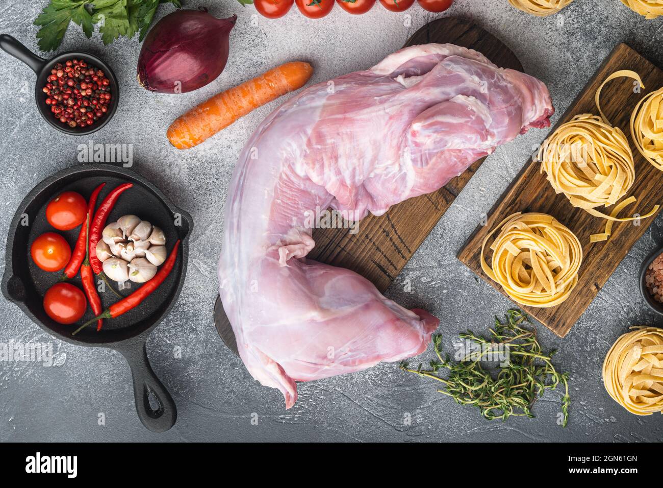 Raw whole rabbit with fresh vegetables and pasta for rabbit stew set ...